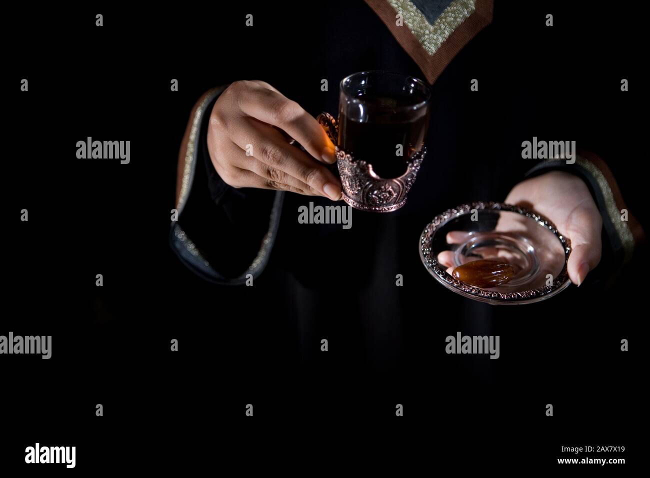 An arab woman holding the gawa (Arabian Coffee Stock Photo - Alamy