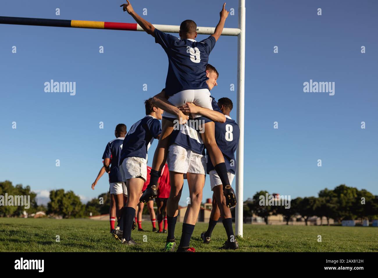 Rugby team carrying a player Stock Photo - Alamy