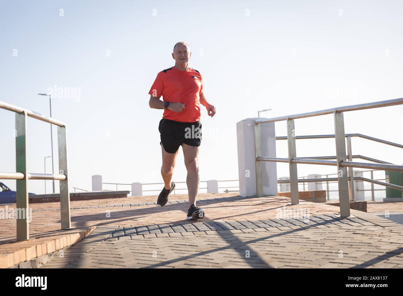 Jogger running on seaside Stock Photo - Alamy