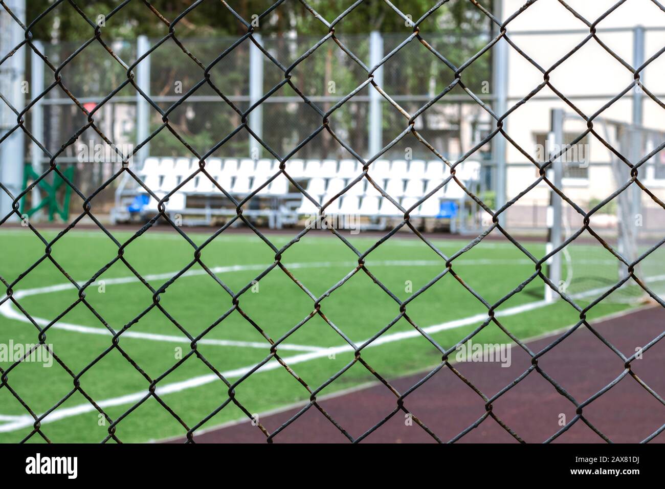 Football field and gates behind the grid Stock Photo - Alamy