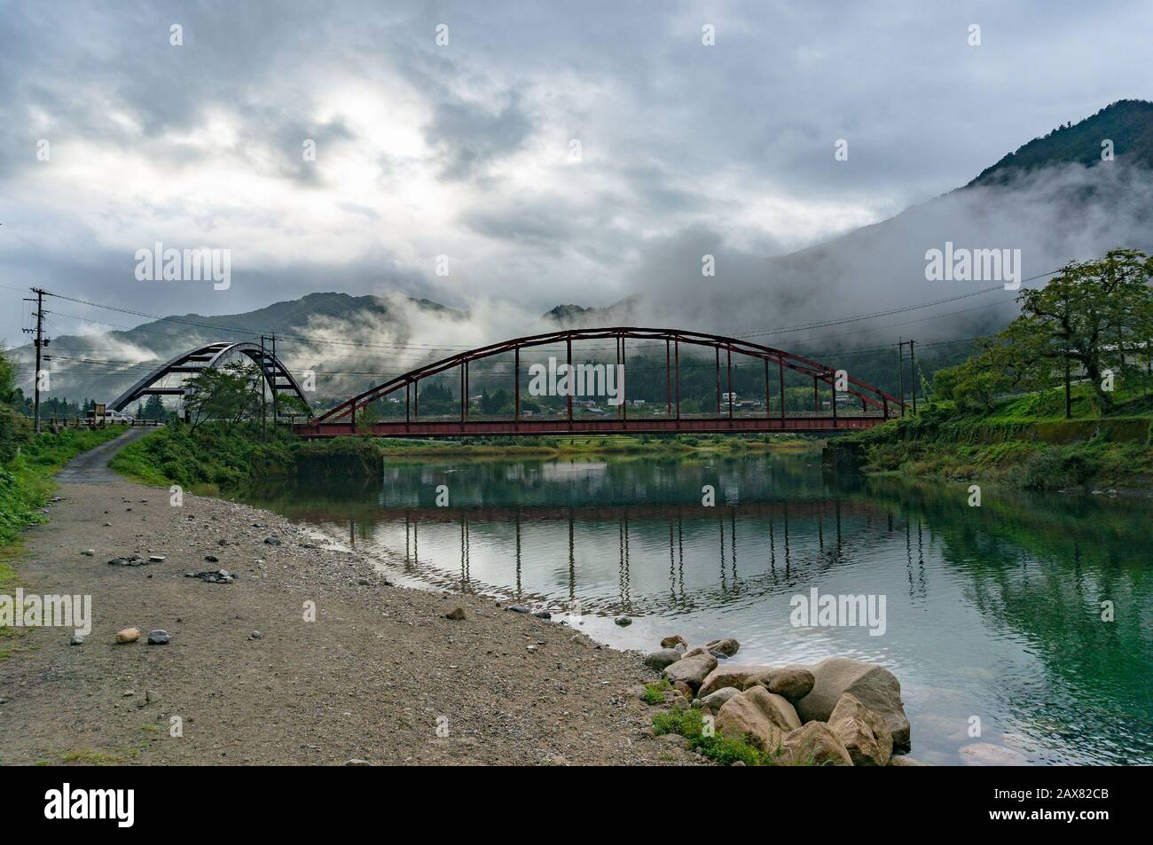 Japanese countryside landscape with two bridges over river and low ...