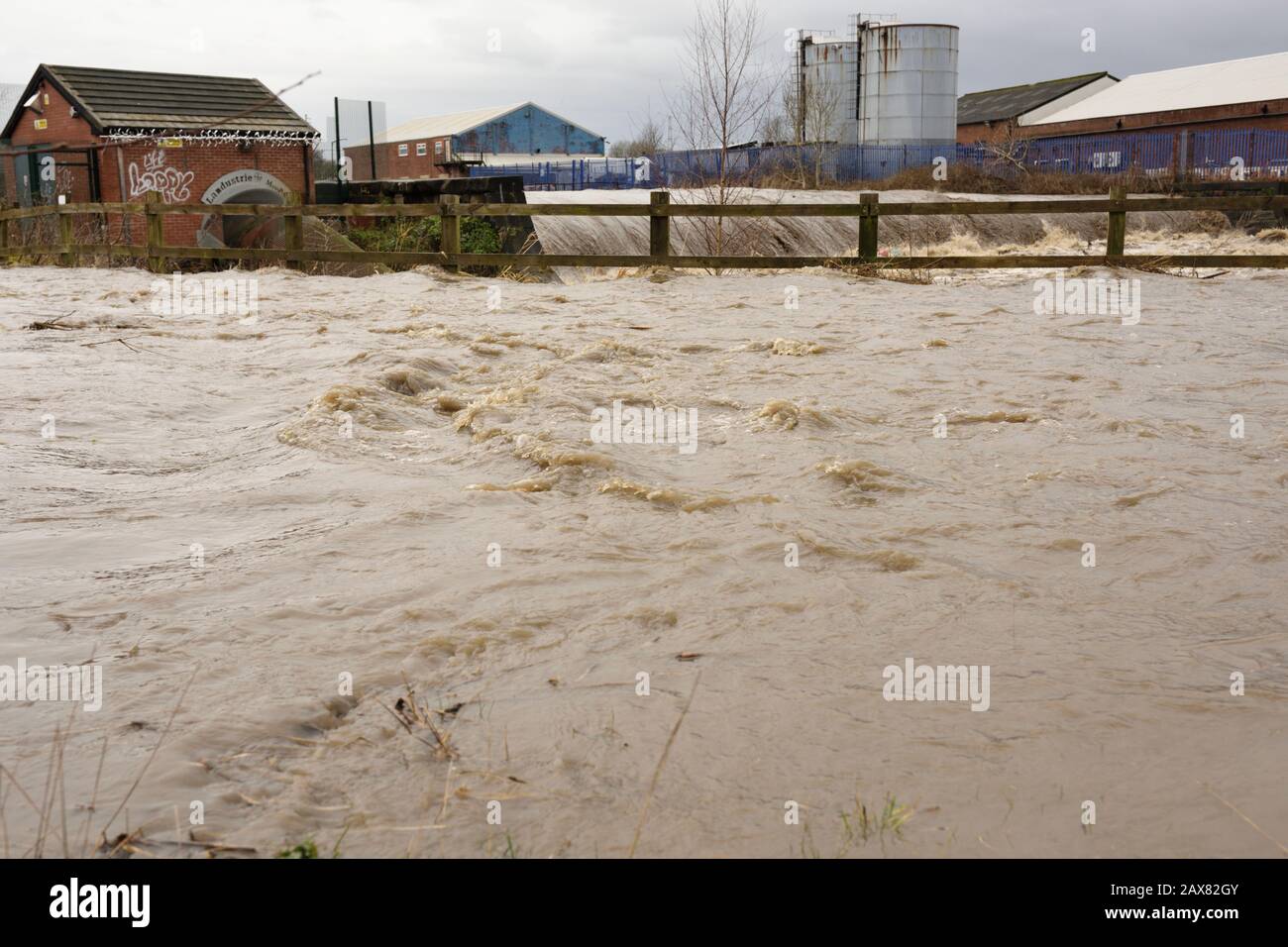 Storm ciara, River irwell bursts its banks with industrial buildings in ...