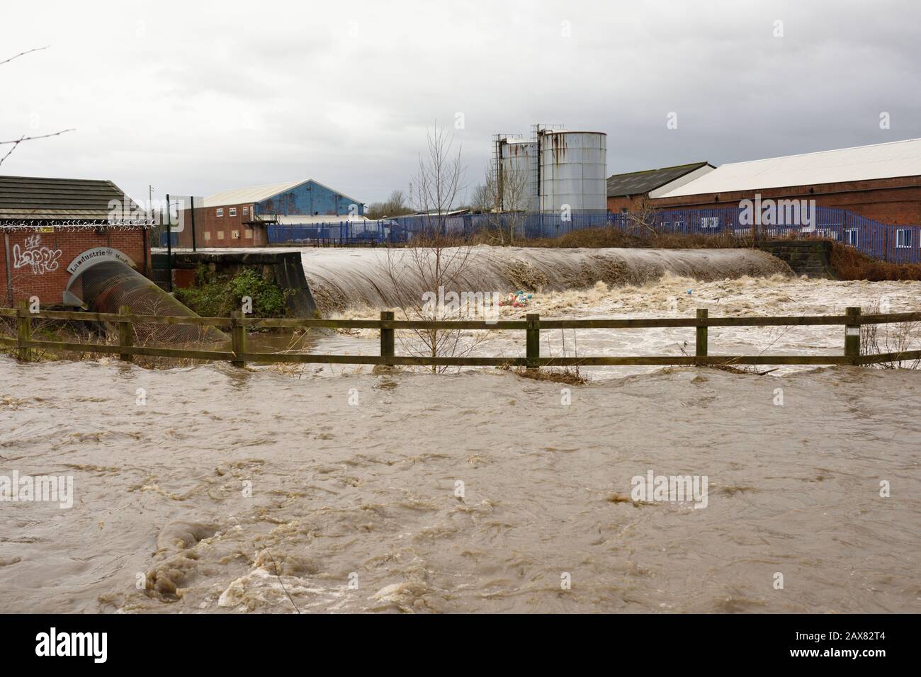 Storm ciara, River irwell bursts its banks with industrial buildings in ...