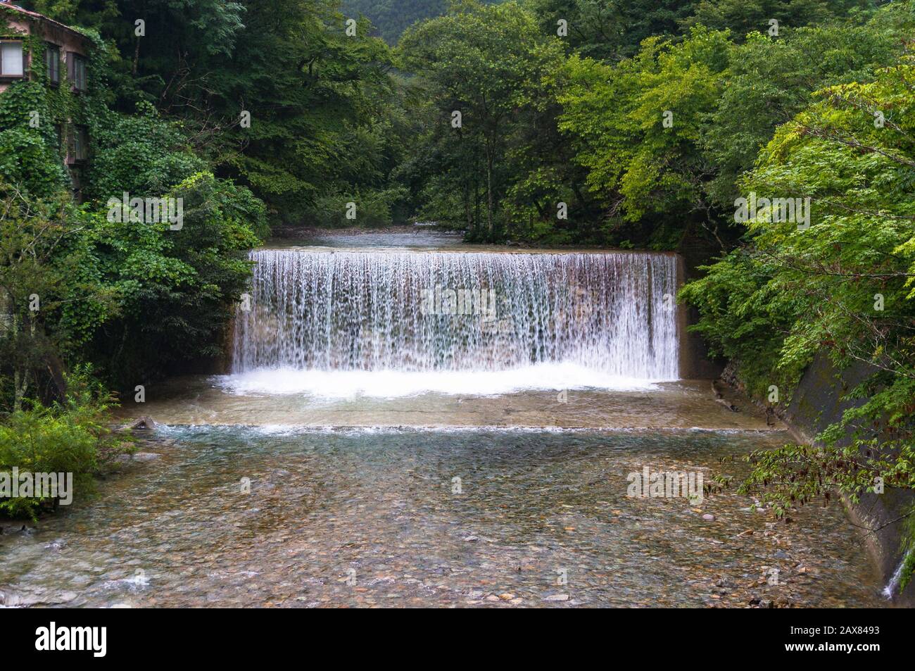 Koizumi Techno waterfall surrounded by green trees Stock Photo - Alamy
