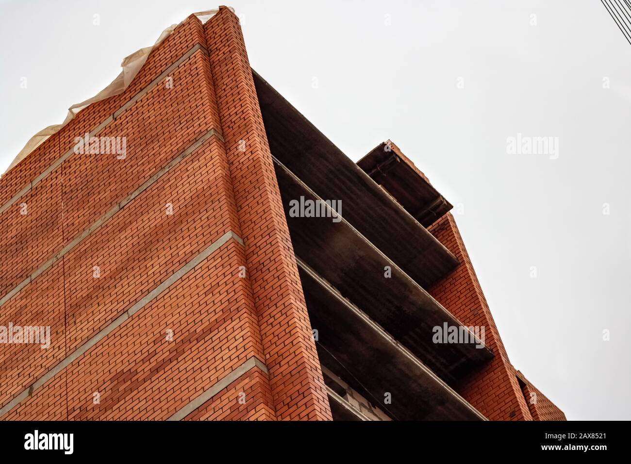 Building red brick house on sky background, bottom view Stock Photo - Alamy