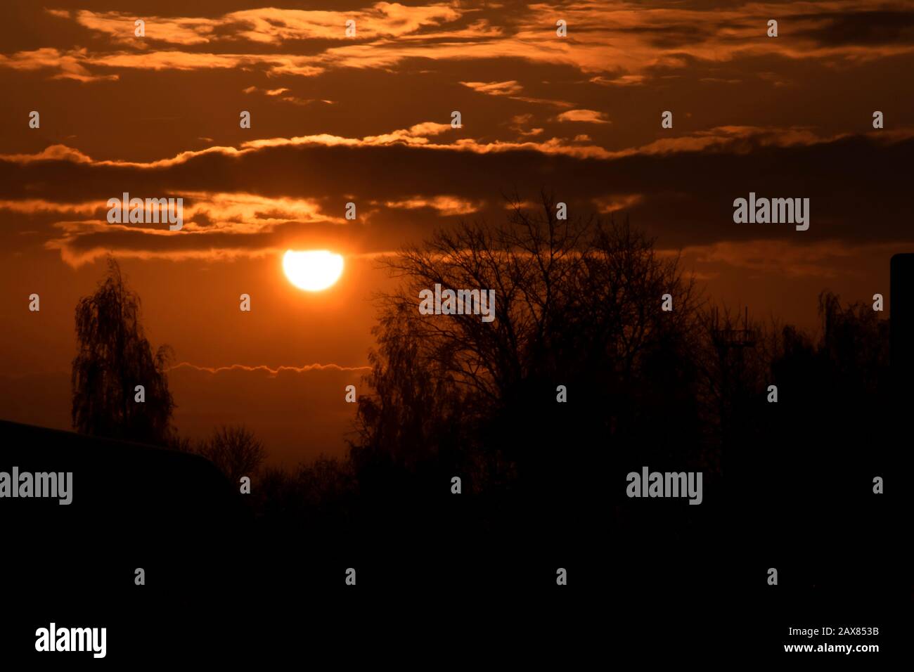 Sun in the red sky at sunrise Stock Photo - Alamy