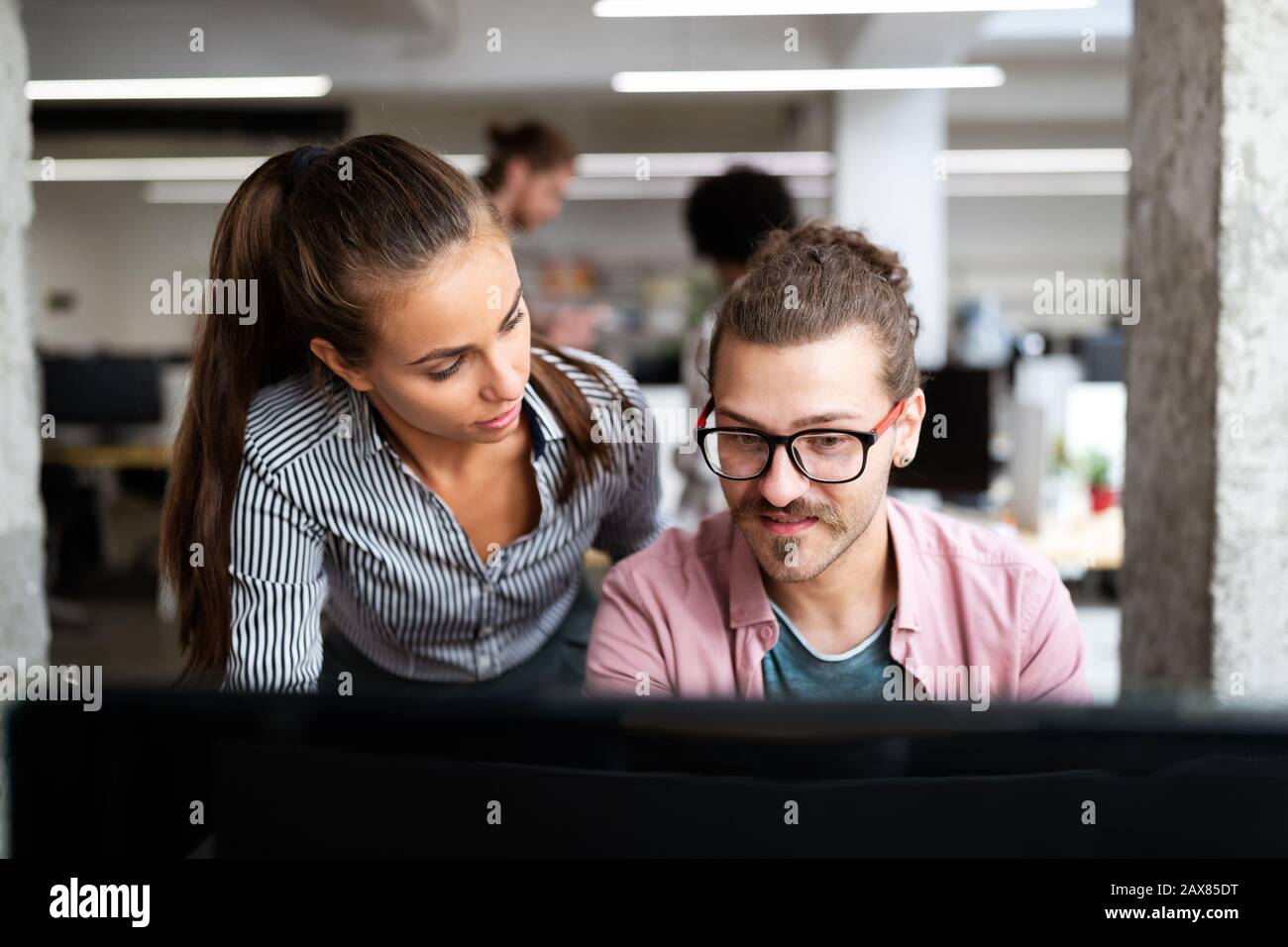 Programmers cooperating brainstorming at information technology company ...