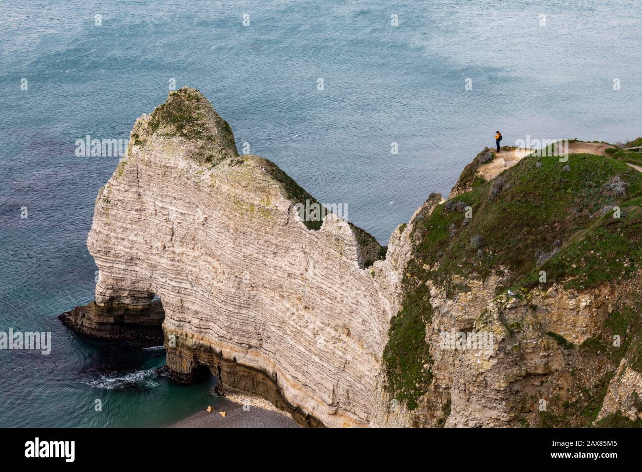 Etretat, Normandy, France - A man standing at the top of the nortern ...