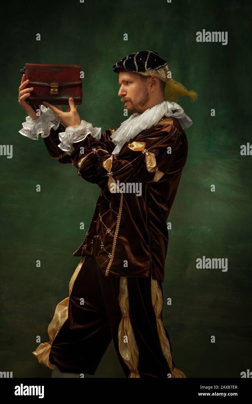 Businessman's bag. Portrait of medieval young man in vintage clothing ...