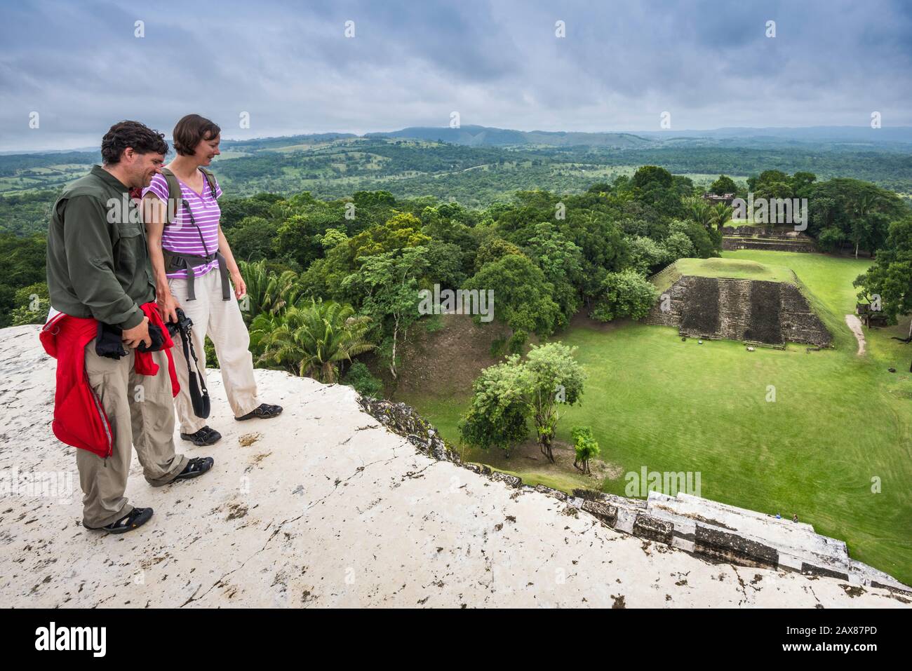 Tourists looking from El Castillo aka Structure A-6 at Xunantunich ...