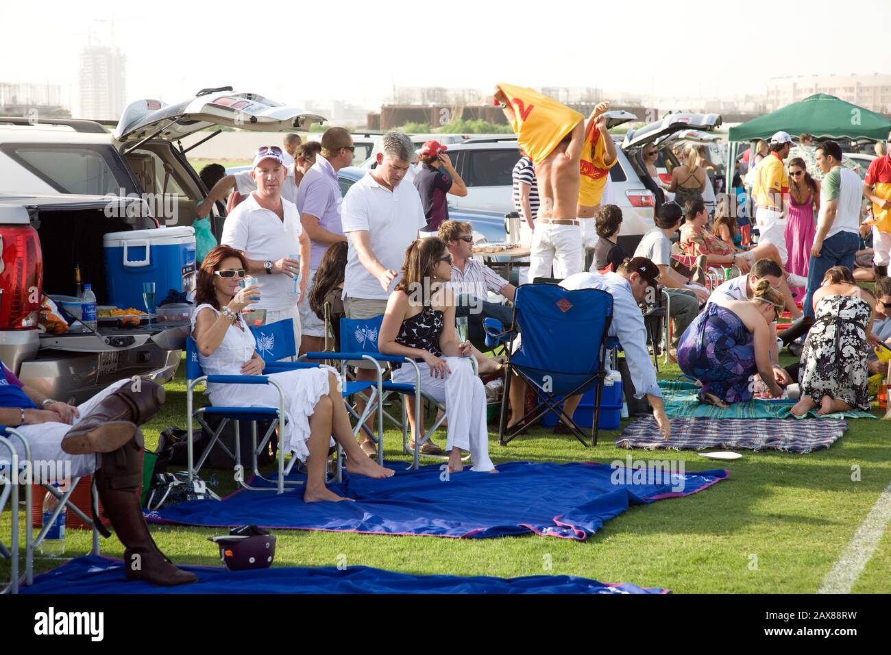 Spectators watch the action of a late afternoon polo game at the polo ...