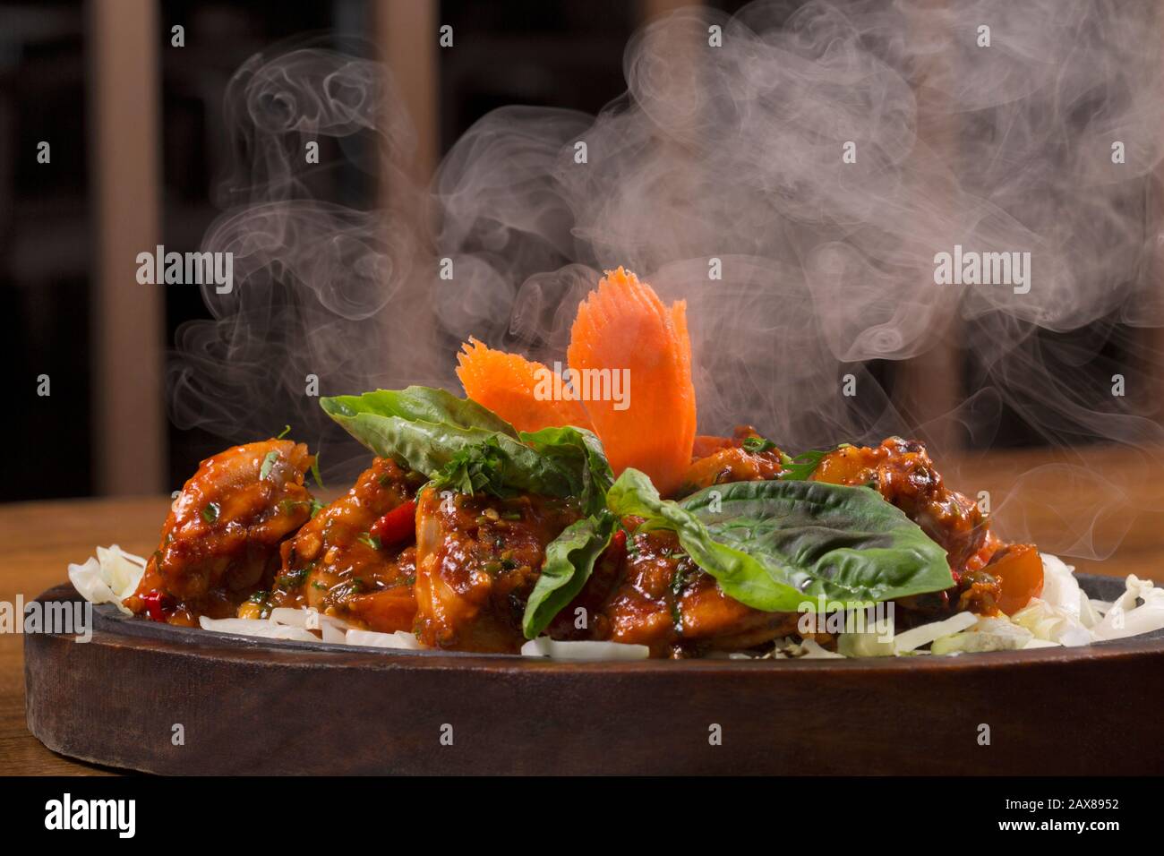 Chili Chicken served on a hot plate Stock Photo - Alamy