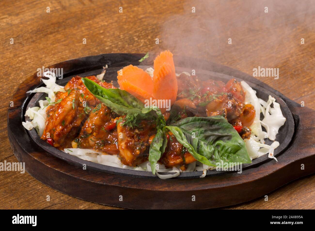 Chili Chicken served on a hot plate Stock Photo - Alamy
