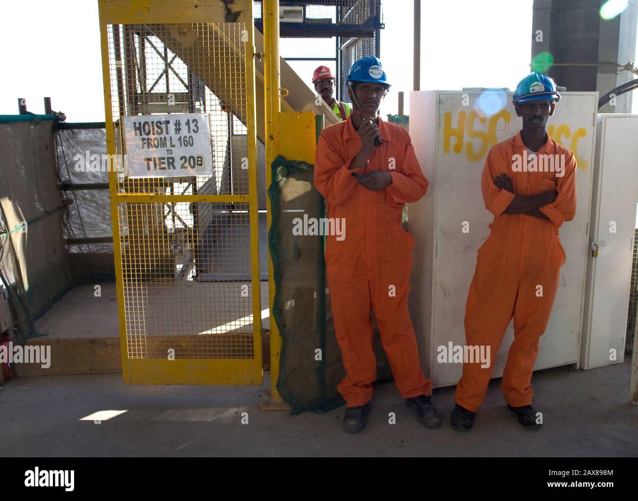 A couple workers pose for a photo on the 160th floor of the Burj ...