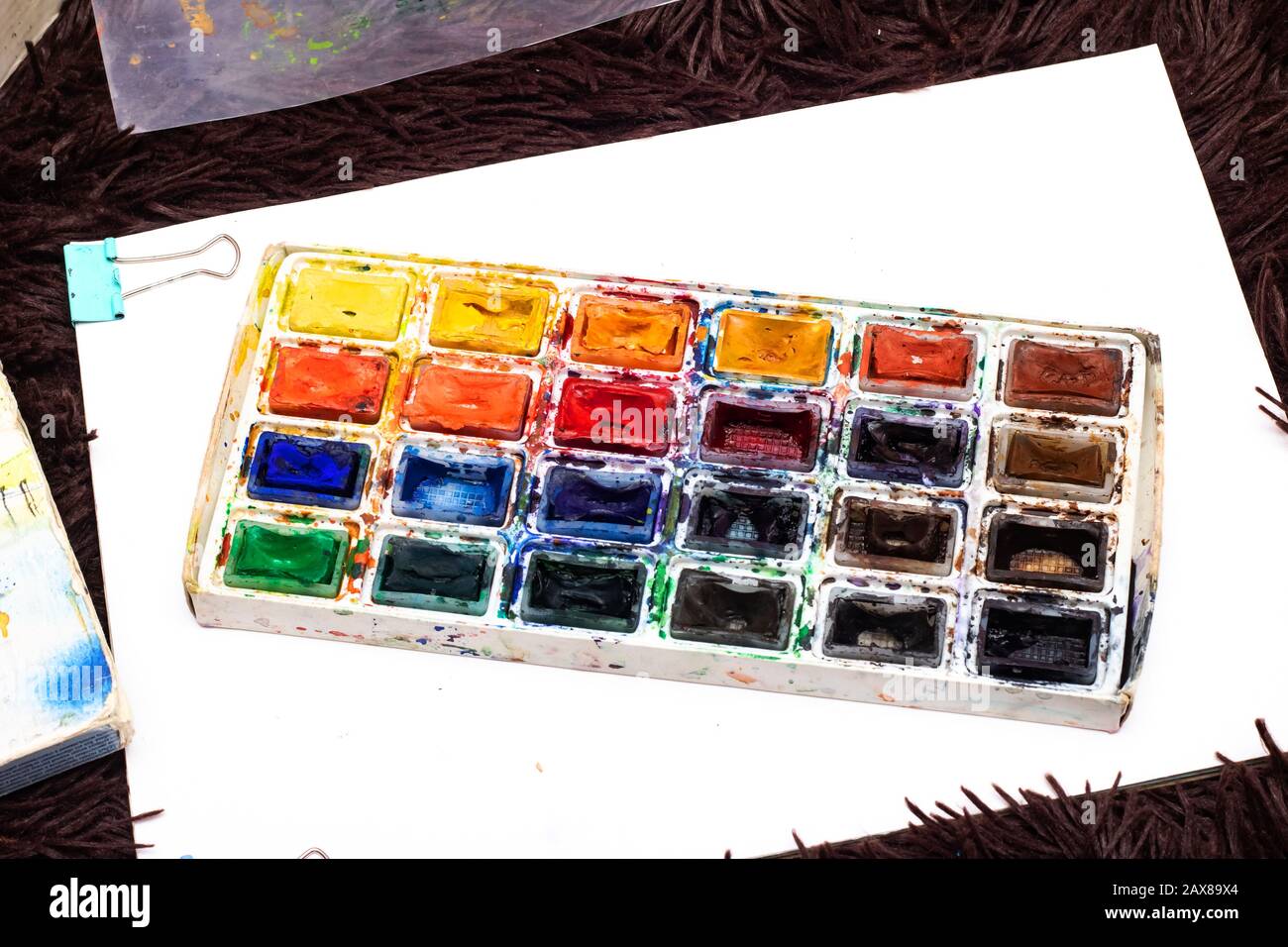 Old color paints on a white sheet of paper Stock Photo - Alamy