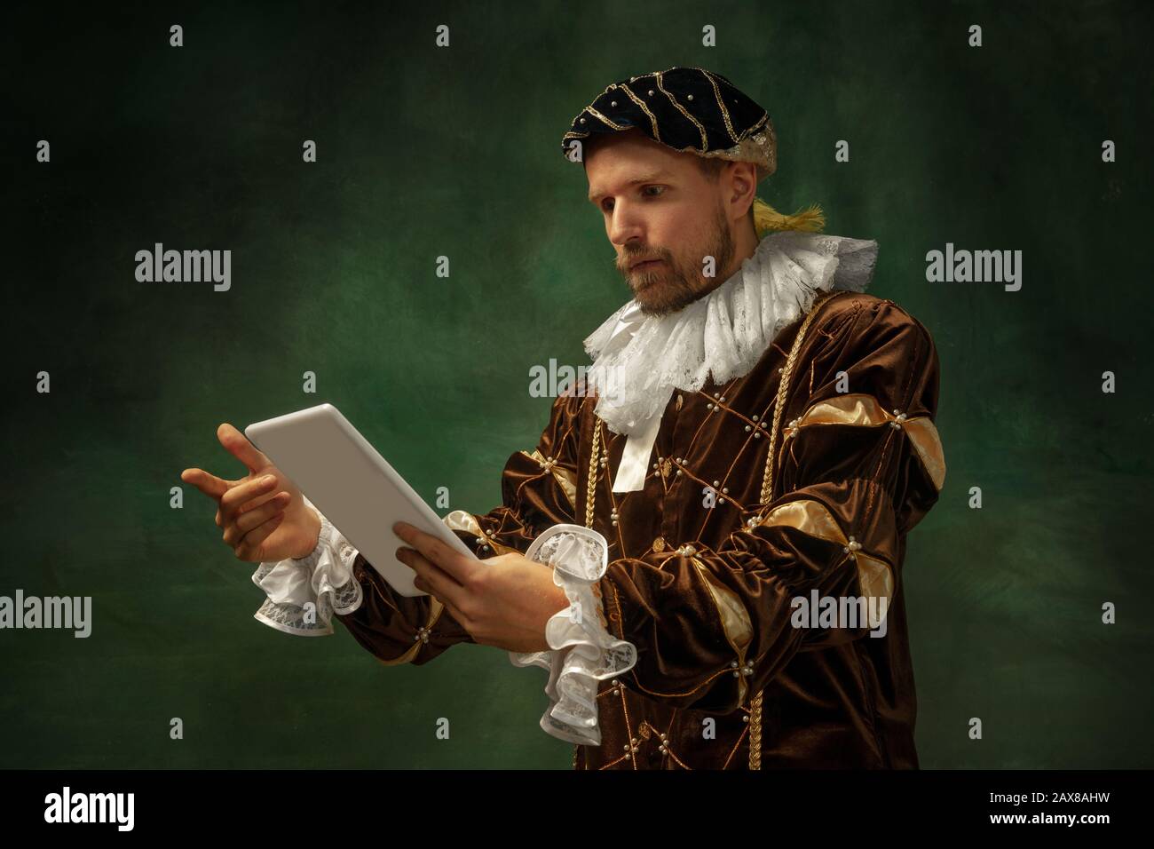 That's technology. Portrait of medieval young man in vintage clothing ...