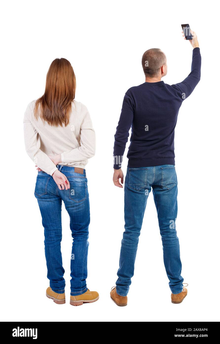 Back view of couple in sweater with mobile phone. beautiful friendly ...