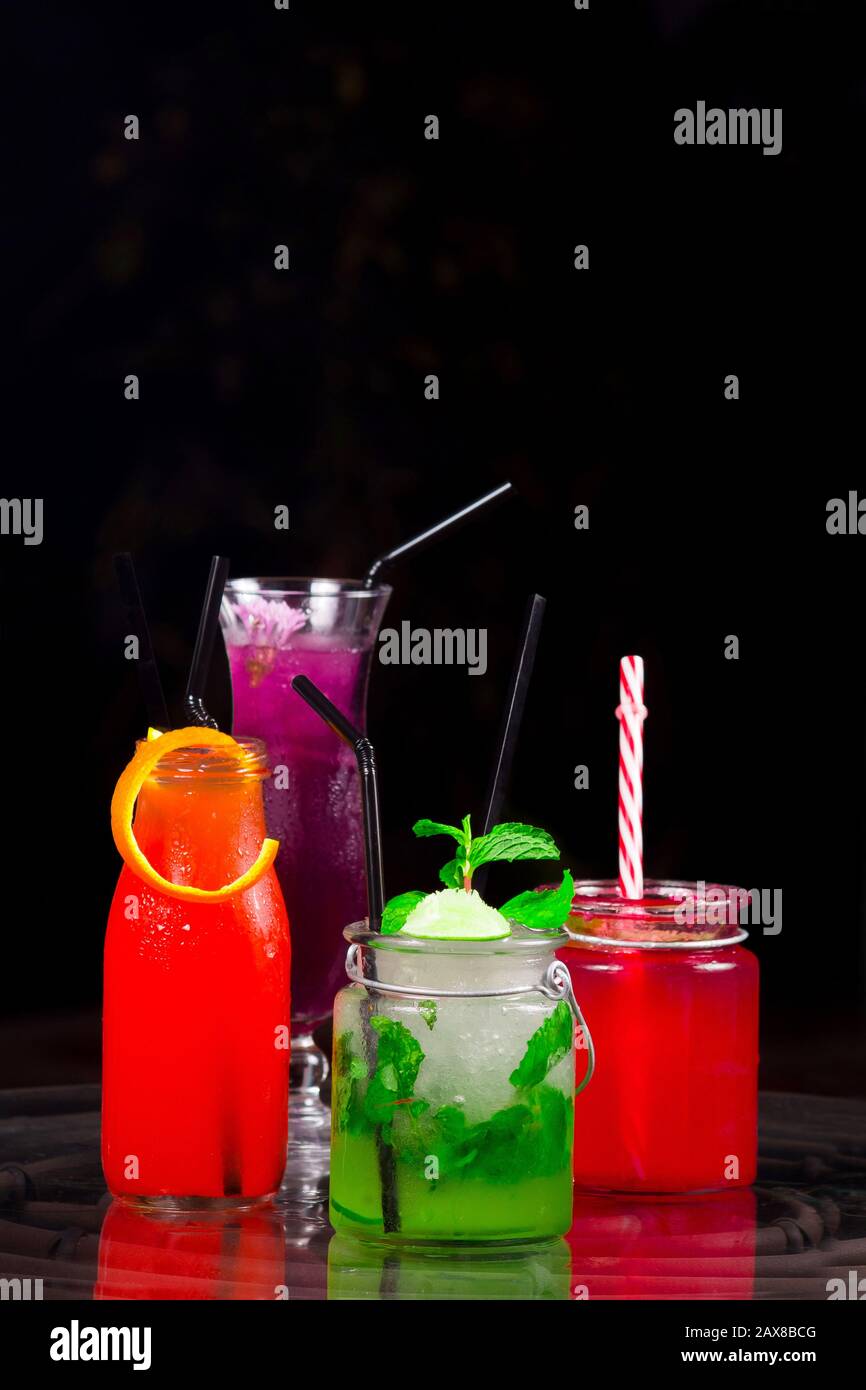 Different colored cocktails at a bar counter Stock Photo - Alamy