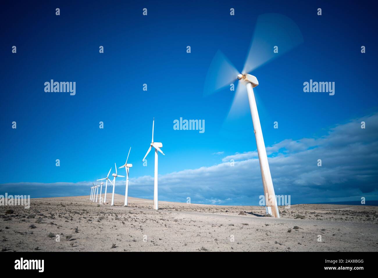 wind turbine in the desert with blue sky background. wind mill farm in ...