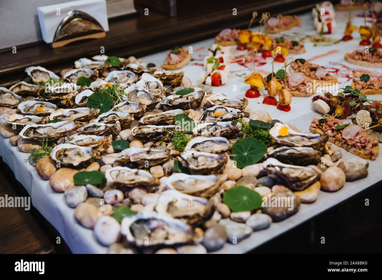 Fresh Oysters on served table. Healthy sea food. Fresh Oyster dinner in ...