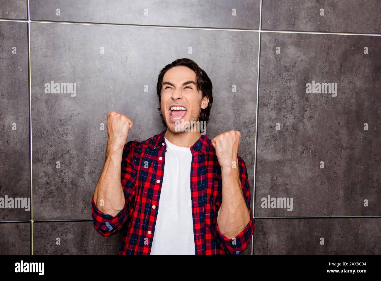 portrait of happy man rise up hands and successful achievement of goals ...