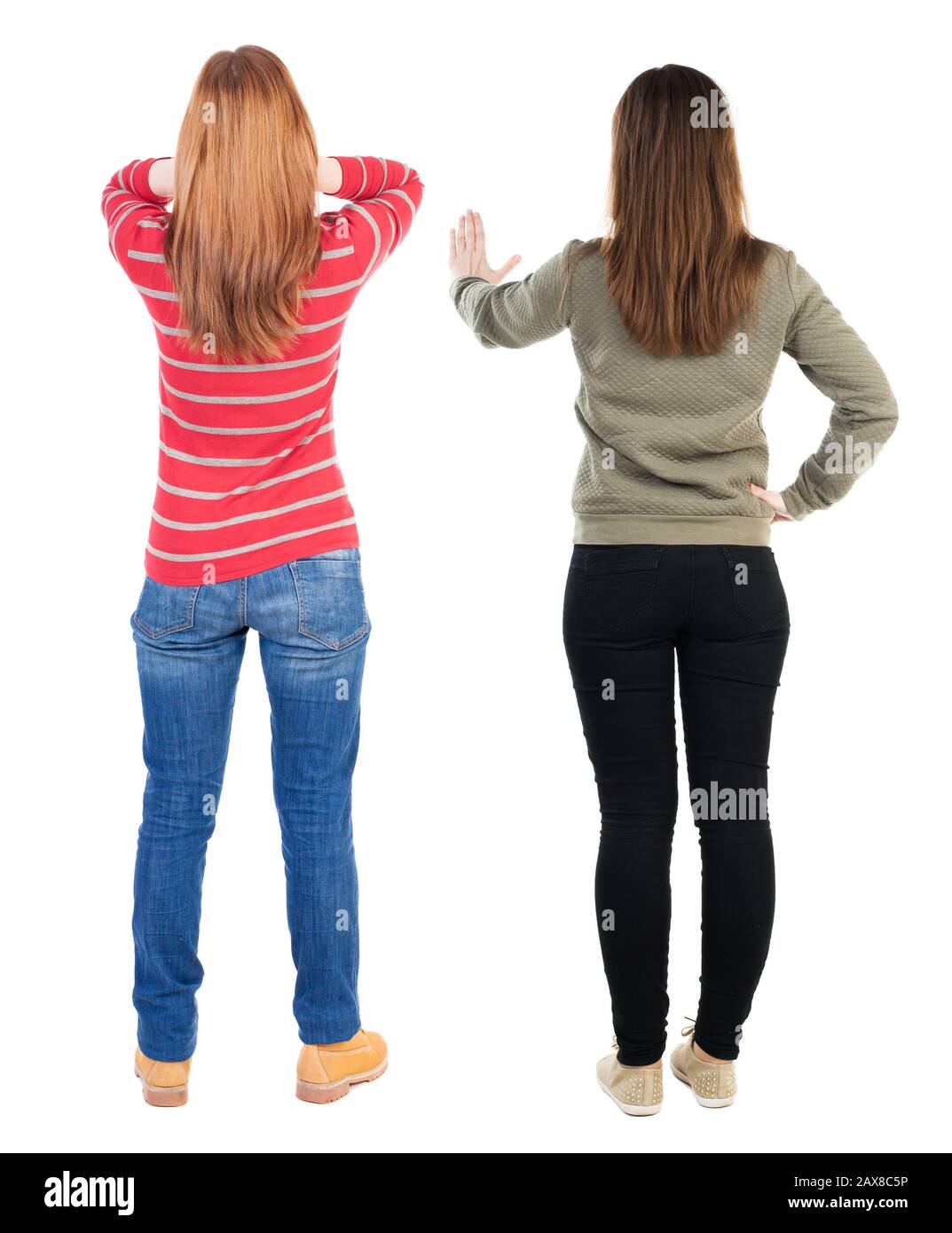 Back view of two pointing young girl in sweater. Rear view people ...