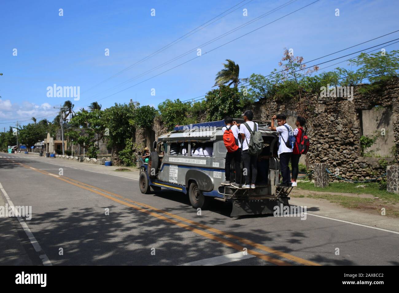 Jeepney driving down a street in The Philippines Stock Photo - Alamy