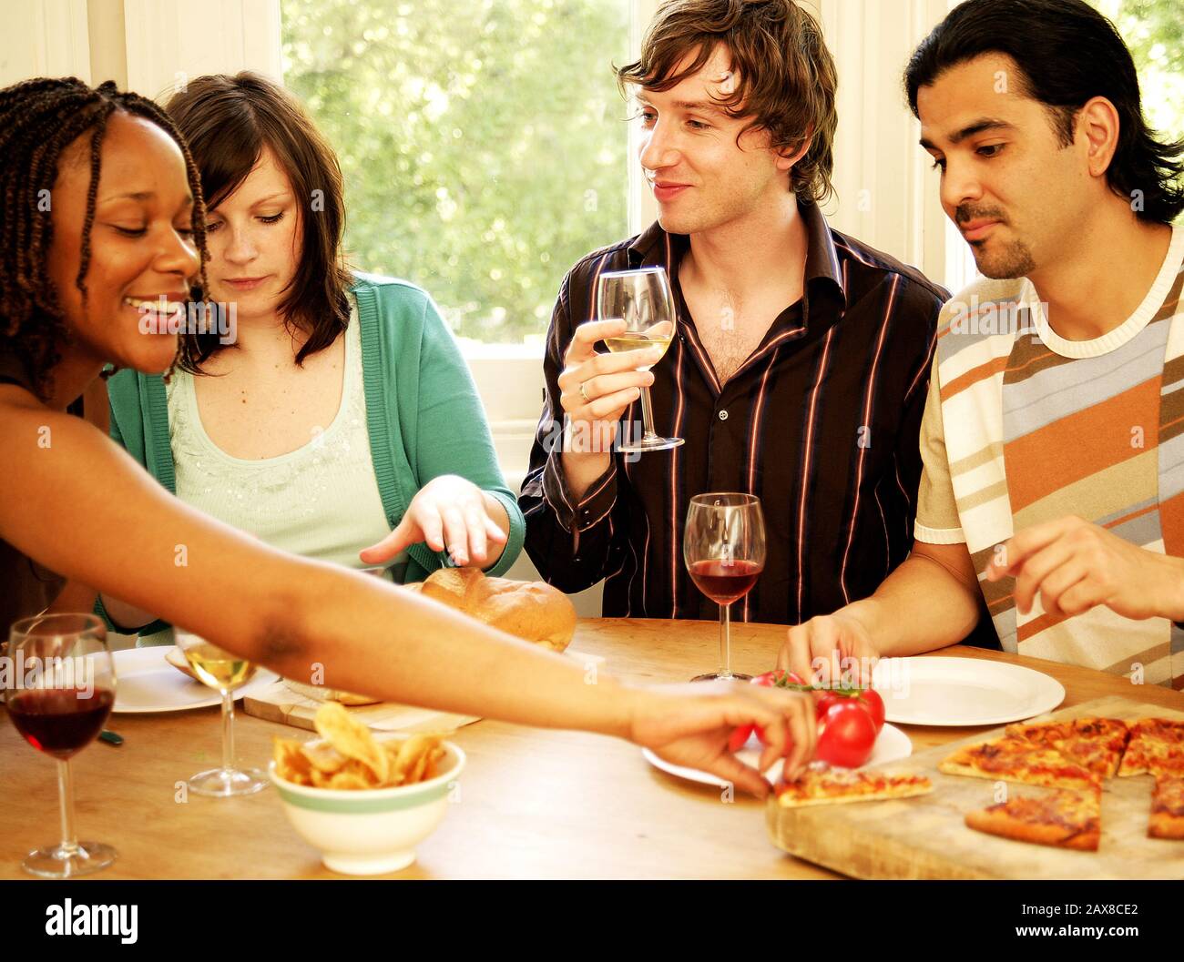 A group of friends eating together Stock Photo - Alamy