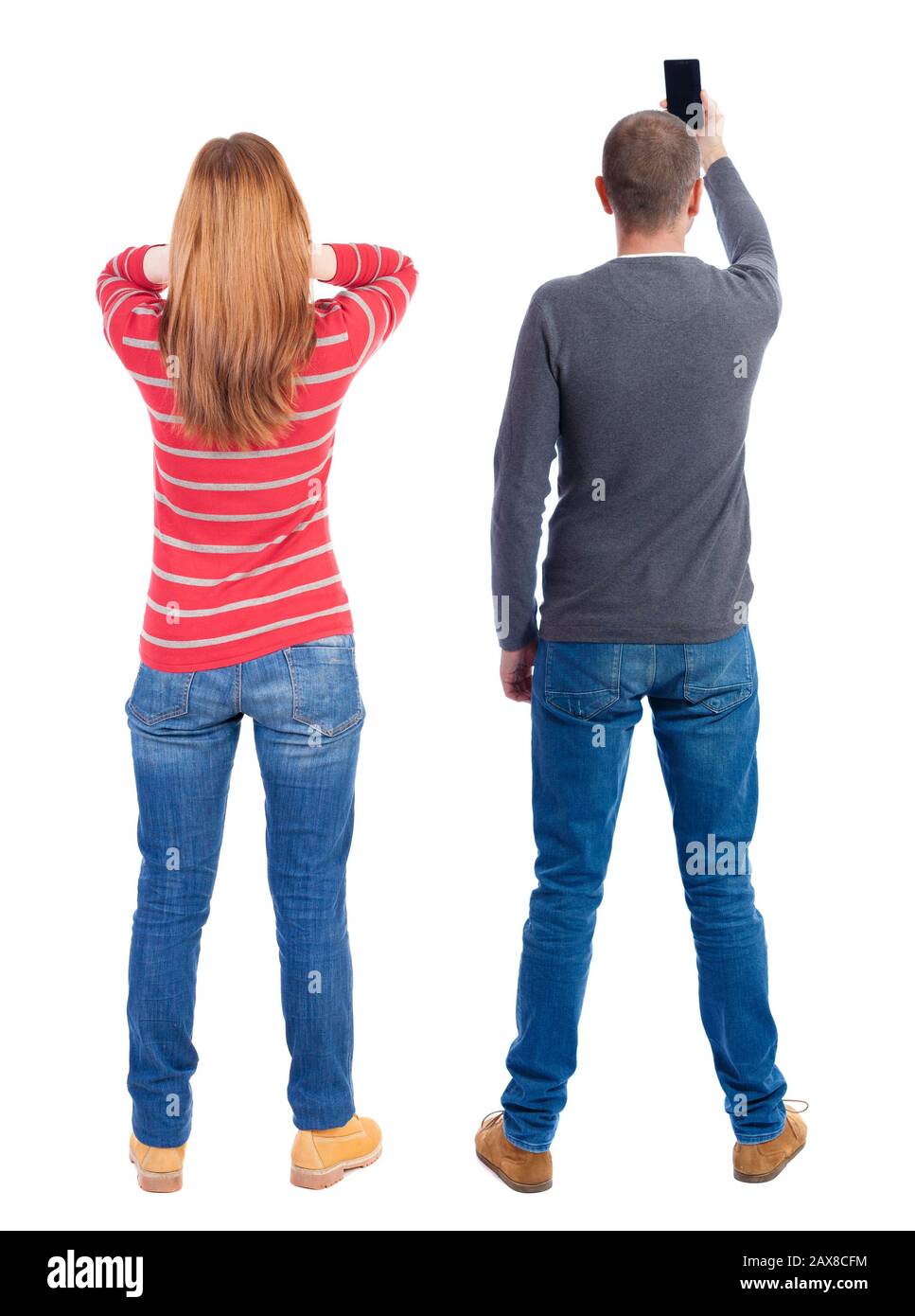 Back view of couple in sweater with mobile phone. beautiful friendly ...