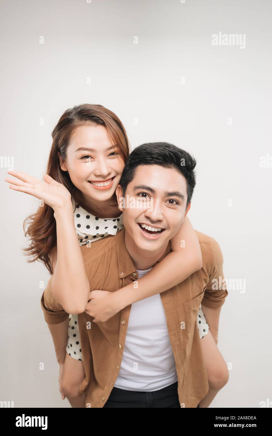 Image of lovely couple having fun while man piggybacking his girlfriend ...