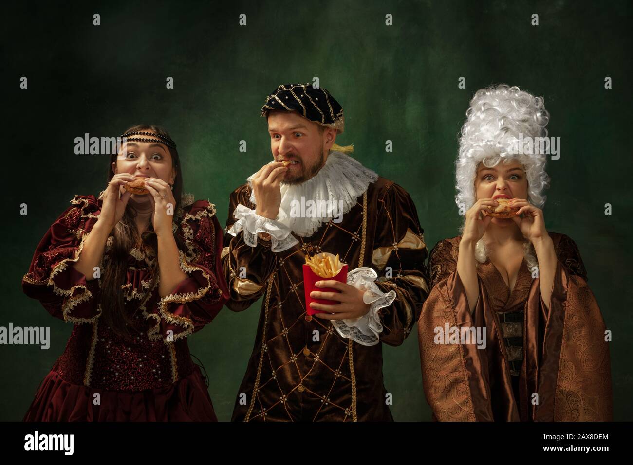 Taste of future. Portrait of medieval young people in vintage clothing ...