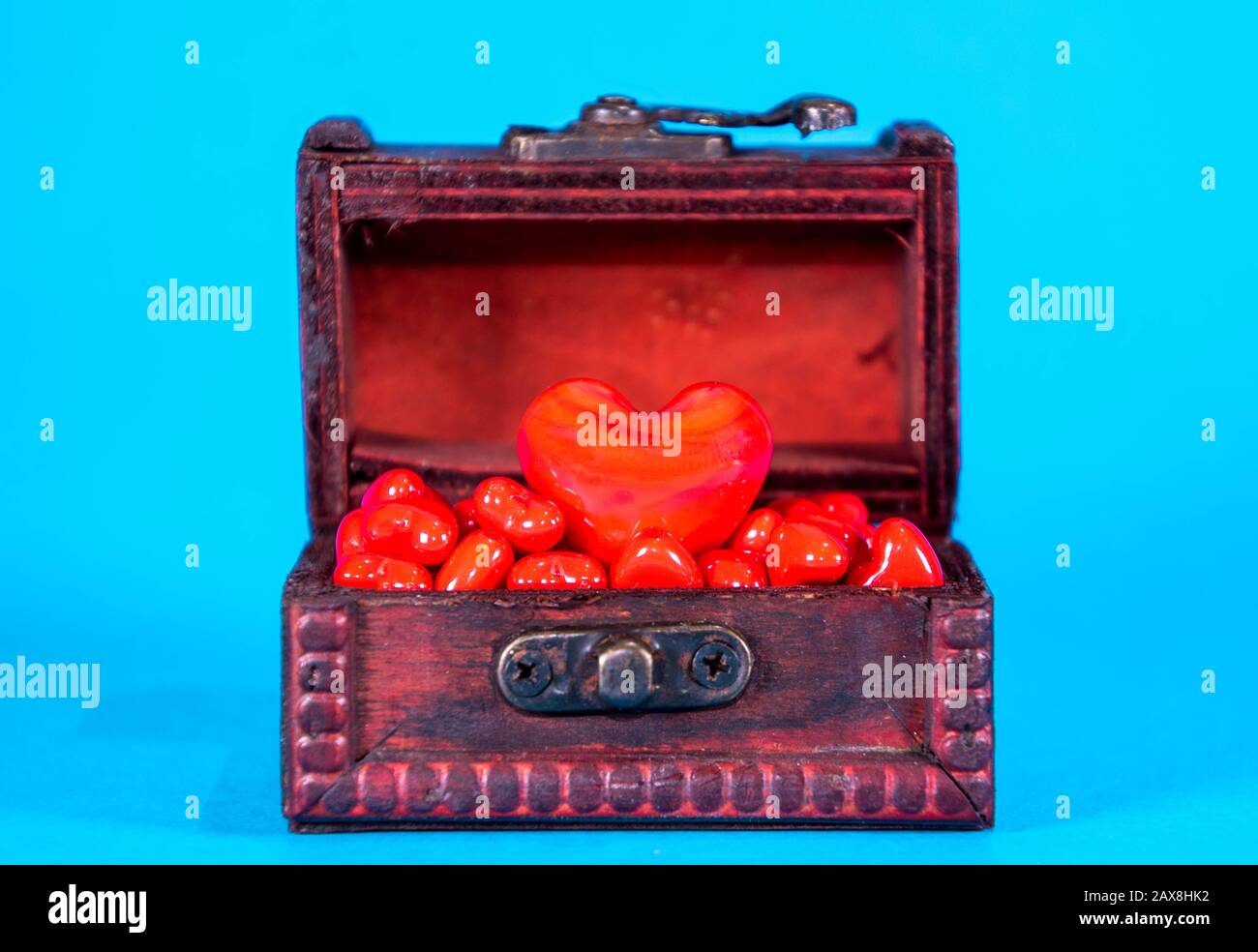 A treasure chest full of love hearts, taken on a bright blue background ...