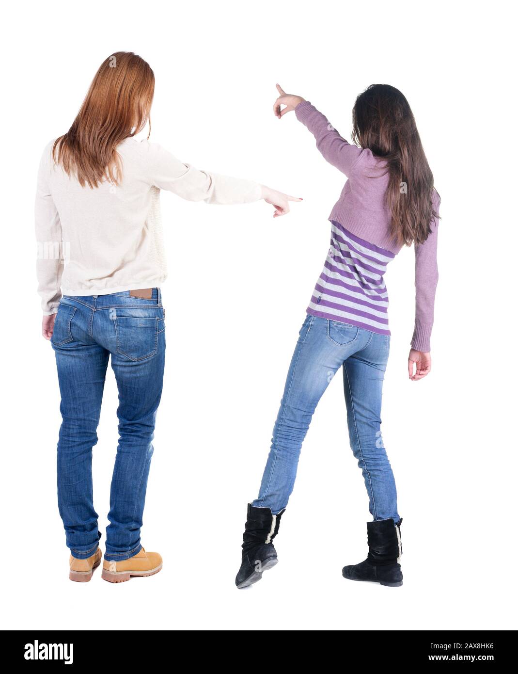 Back view of two pointing young girl in sweater. Rear view people ...