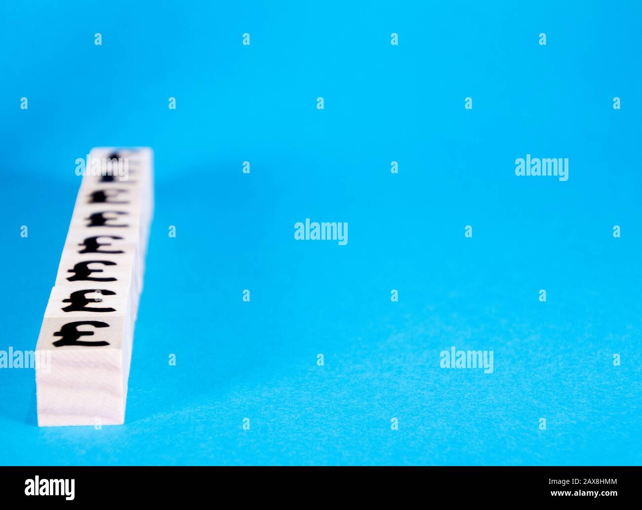 British Pound Sterling currency symbols on wooden blocks, against a ...