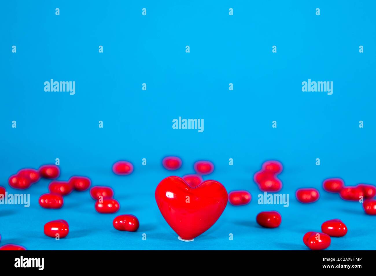 A scattering of love hearts, taken on a bright blue background, with ...