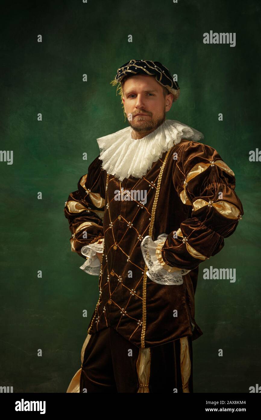 Posing thoughtful. Portrait of medieval young man in vintage clothing ...
