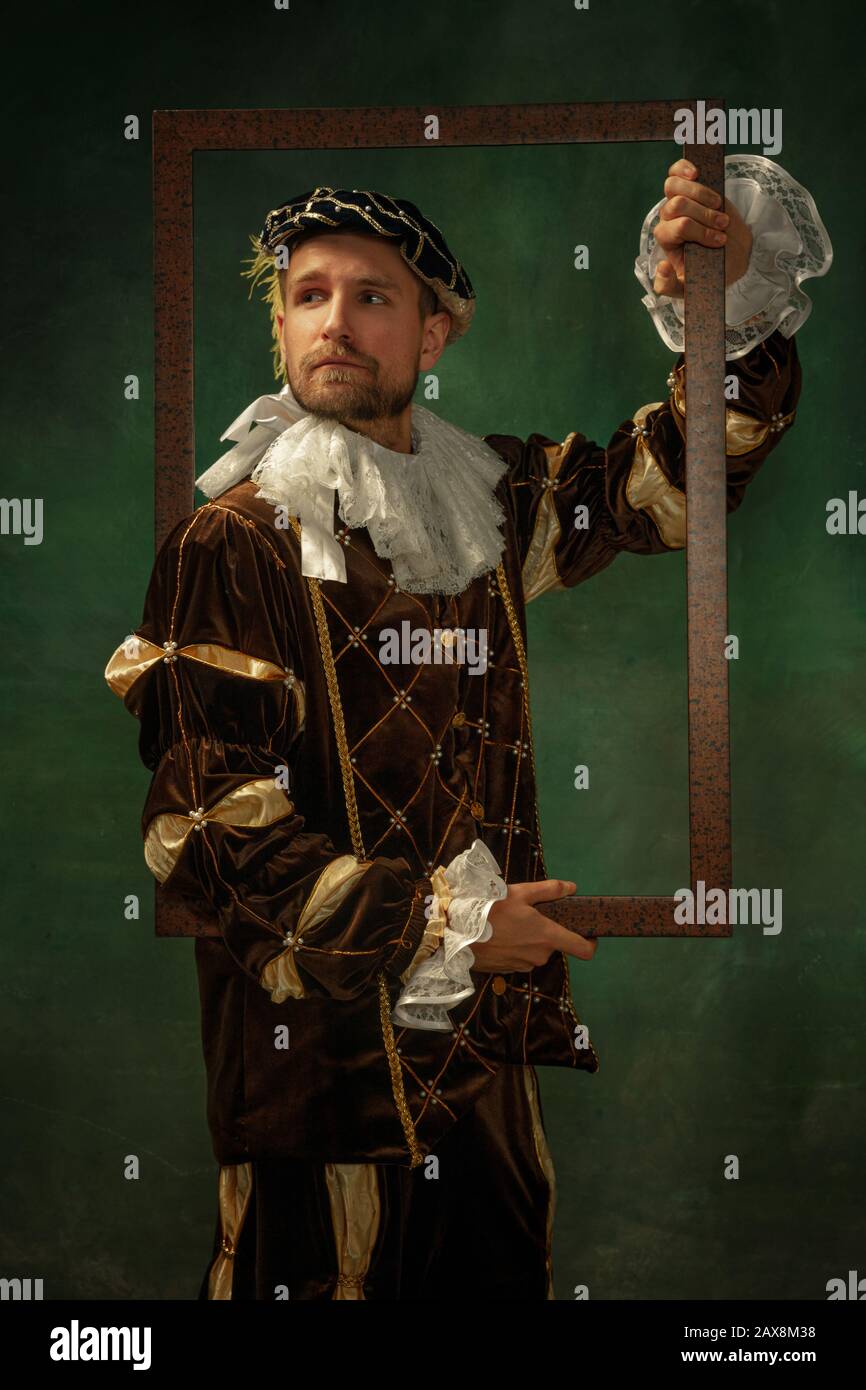 Posing thoughtful. Portrait of medieval young man in vintage clothing ...