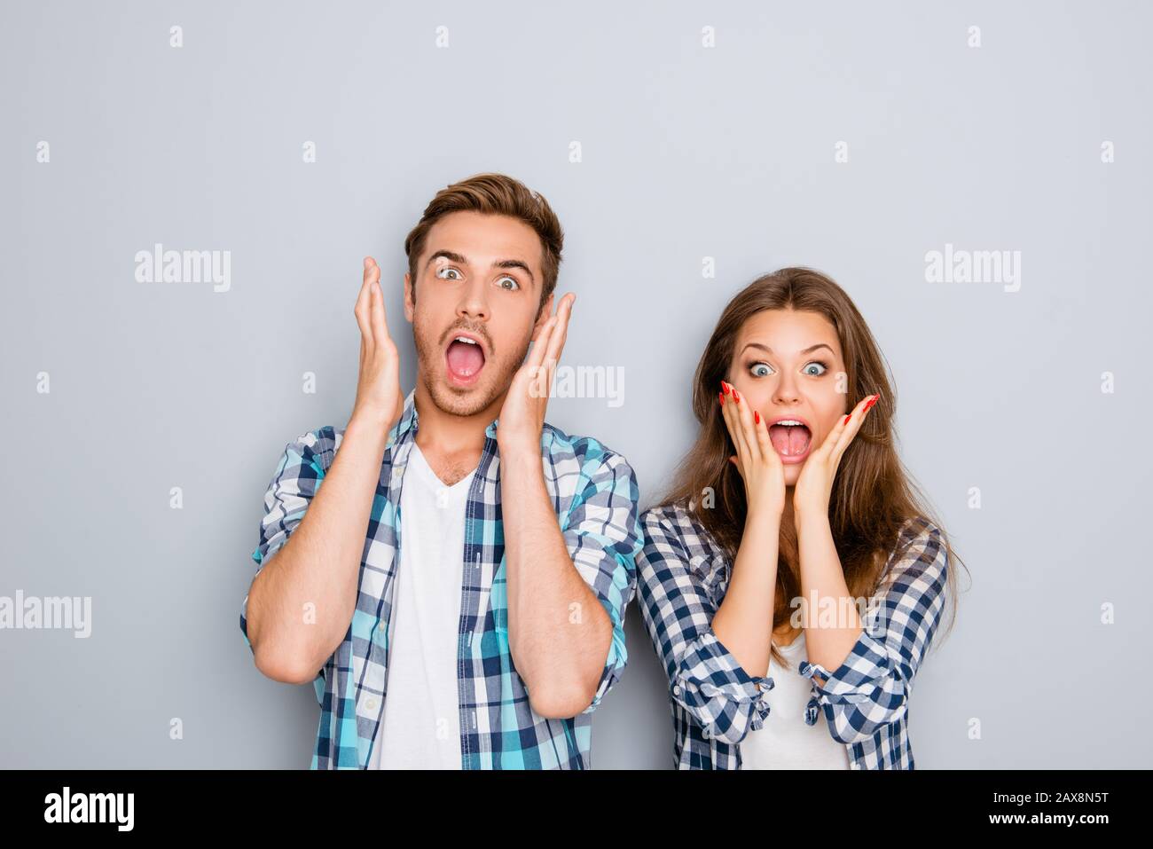 Portrait of shocked man and woman screaming and touching face Stock ...