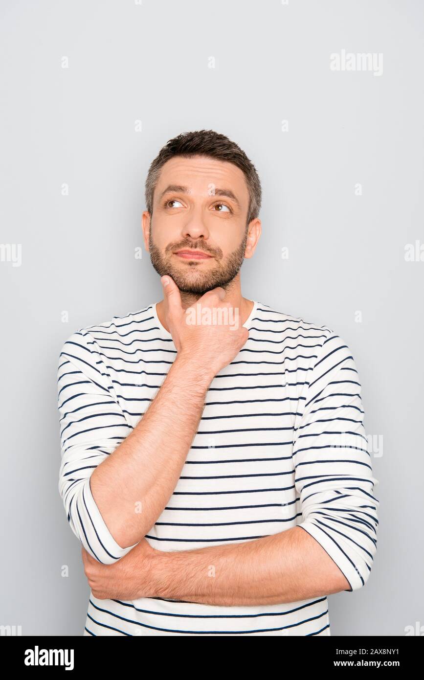 Portrait of young ponder man touching his chin Stock Photo - Alamy