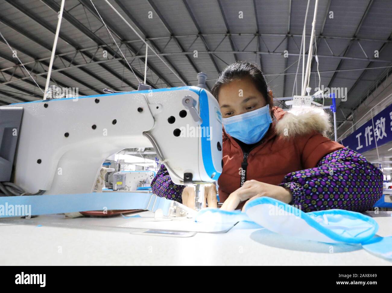 Chinese workers manufacture face masks at a factory during the outbreak ...