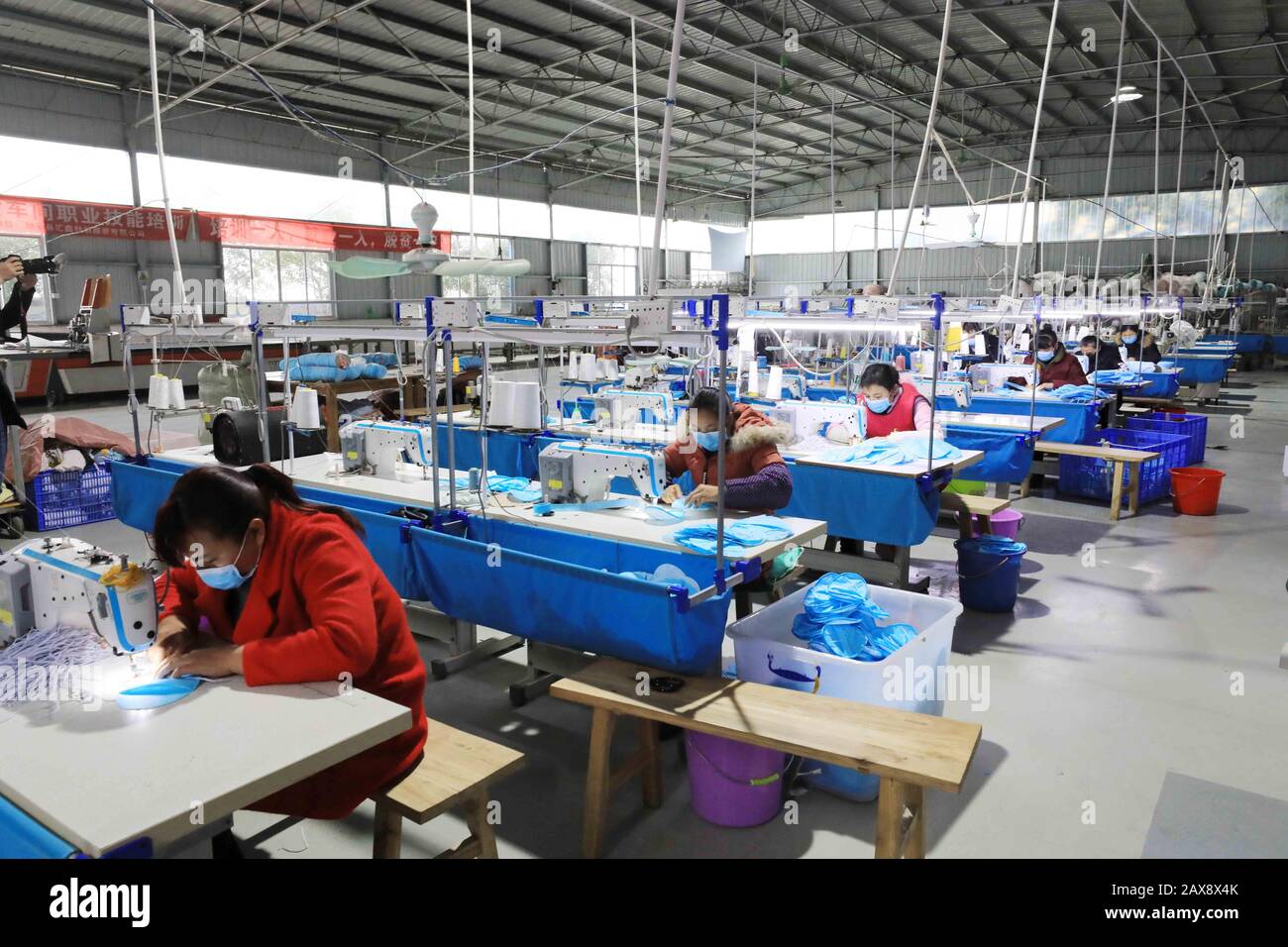 Chinese workers manufacture face masks at a factory during the outbreak ...
