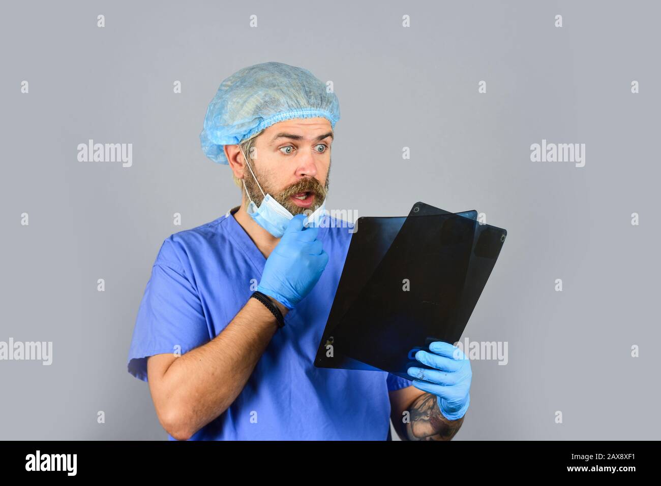 nurse checking x-ray film at hospital. deadly disease. man look at ...