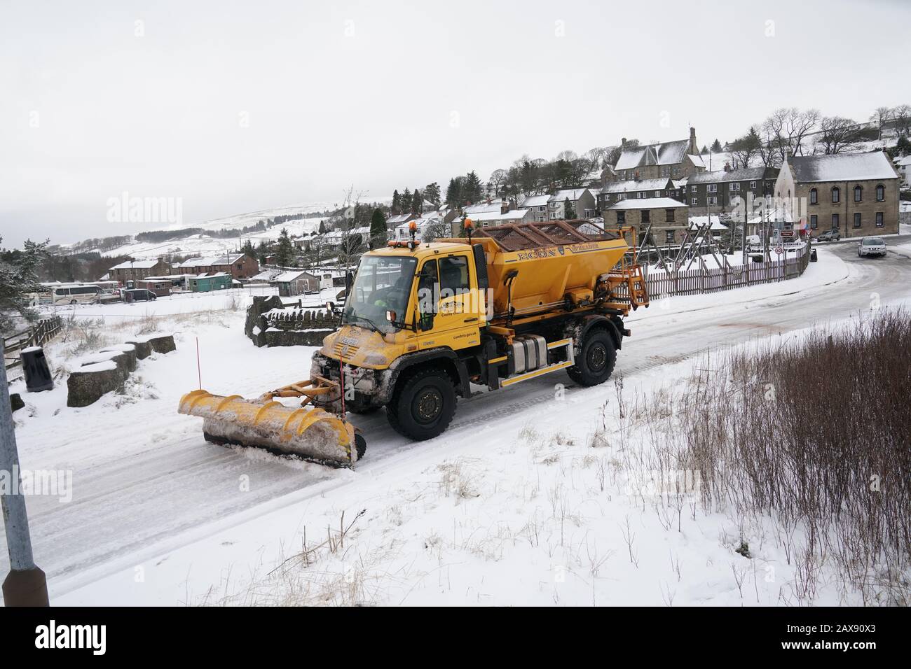 A snow plow clears a road in Nenthead, Cumbria Stock Photo - Alamy