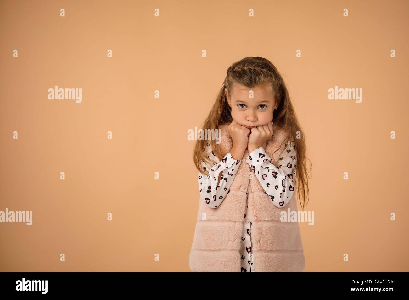 offended sad little child girl on beige background. Human emotions and ...