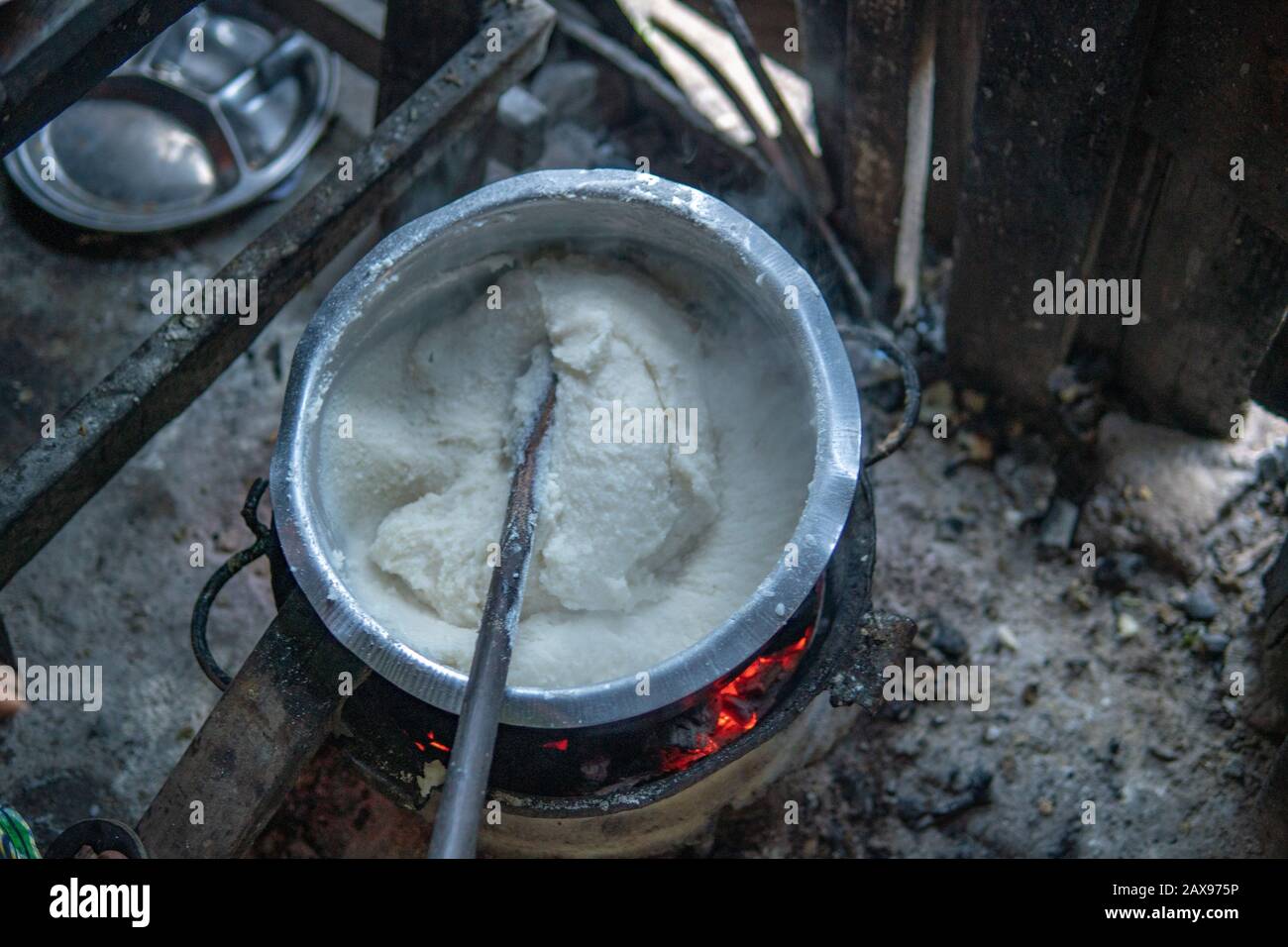 Basic African kitchen. Cooking on the fire Ugali - local food Stock ...