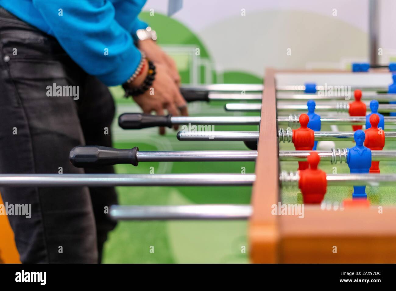 People playing foosball table soccer. Team sport, table football ...