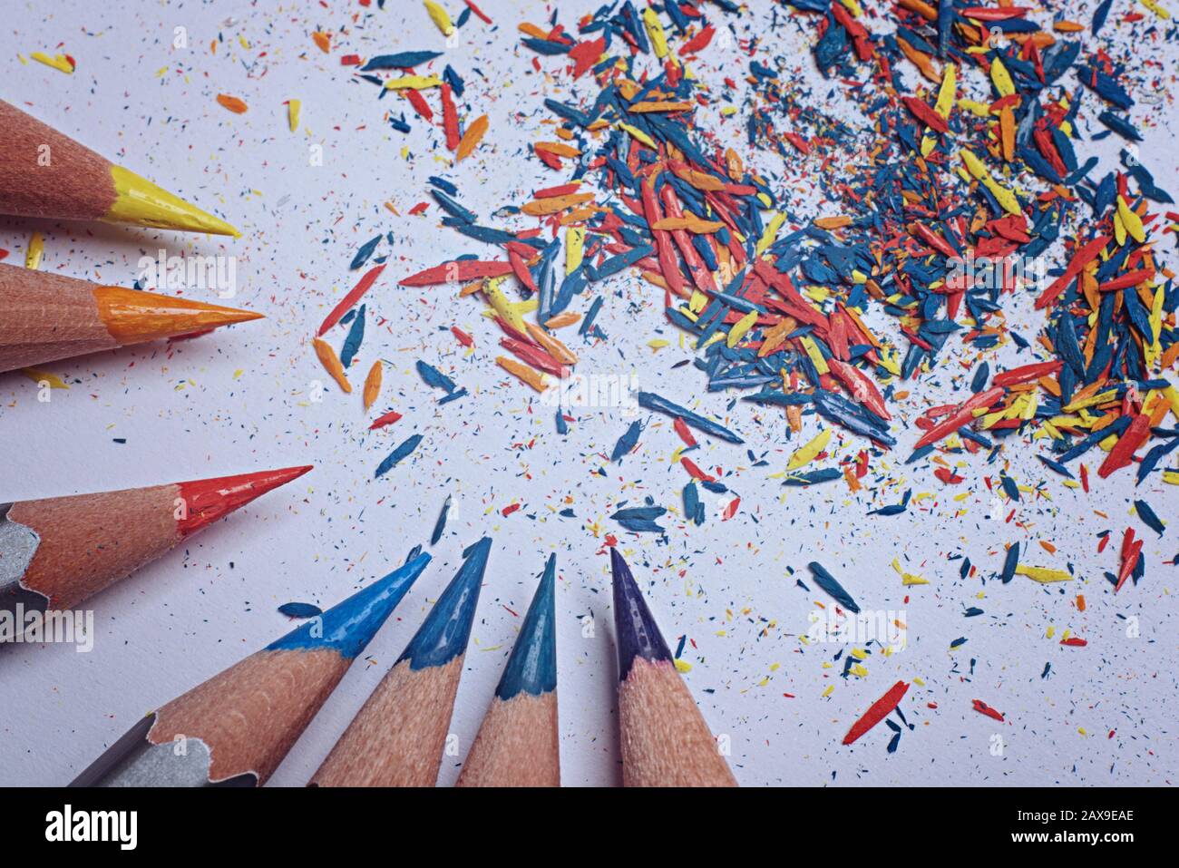 Multi colored pencils and shavings on a white paper Stock Photo - Alamy