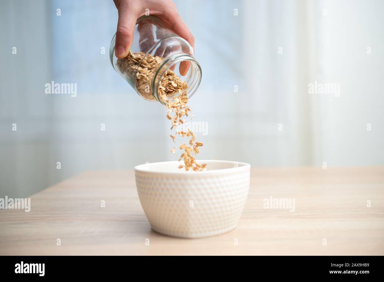 Milk pouring bowl hand hi-res stock photography and images - Alamy