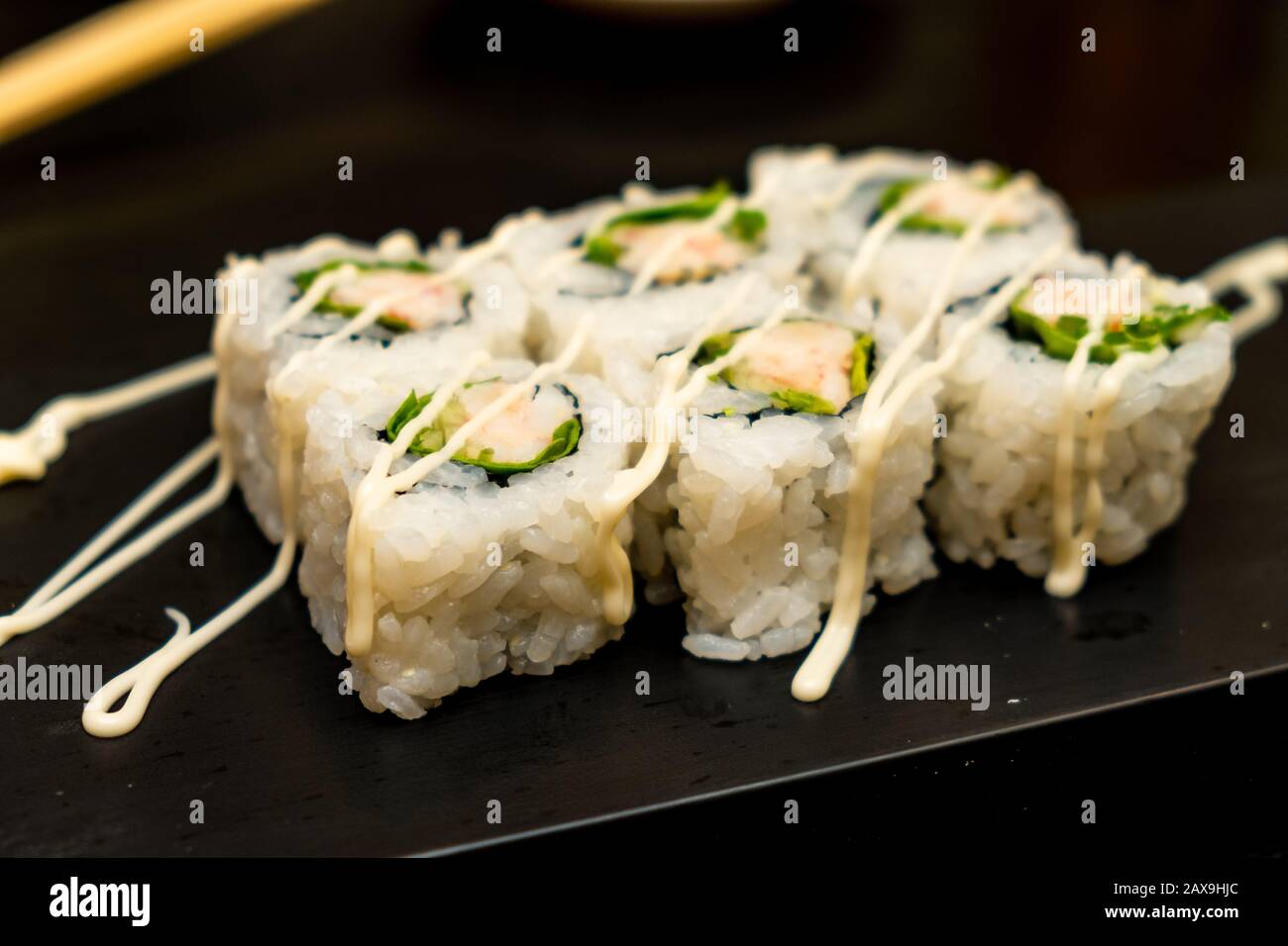 Real Japanese sushi in a restaurant in Tokyo. Set of sushi on a black ...