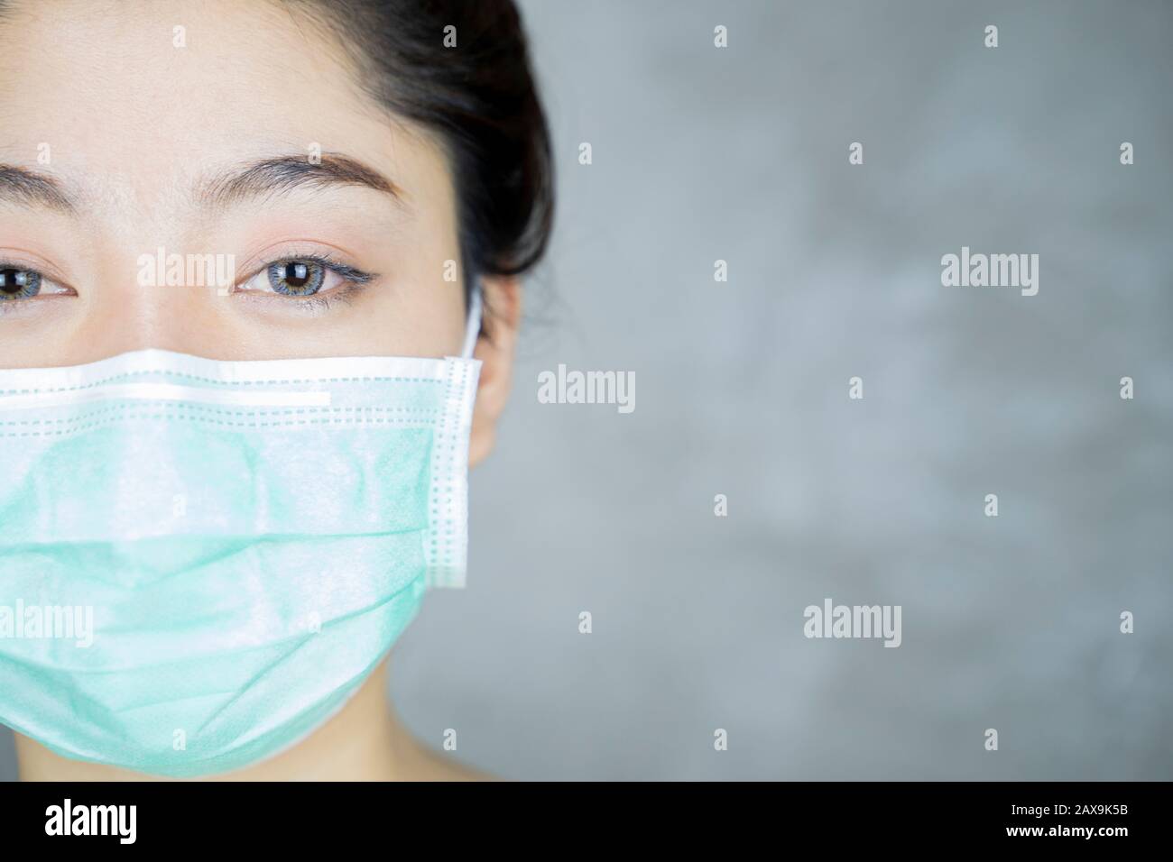 Close up portrait of young asian woman with medicine health care mask ...